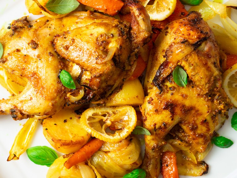 POUSSIN CHICKEN WITH BAKED POTATOES, CARROTS, AND LEMON